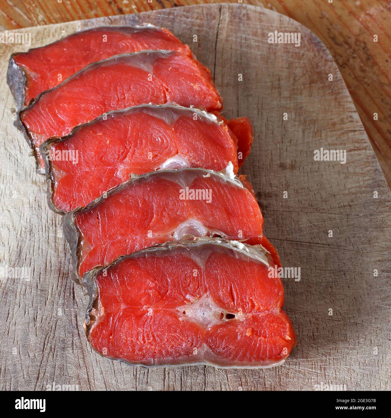 Red fish slices on cutting board Stock Photo - Alamy