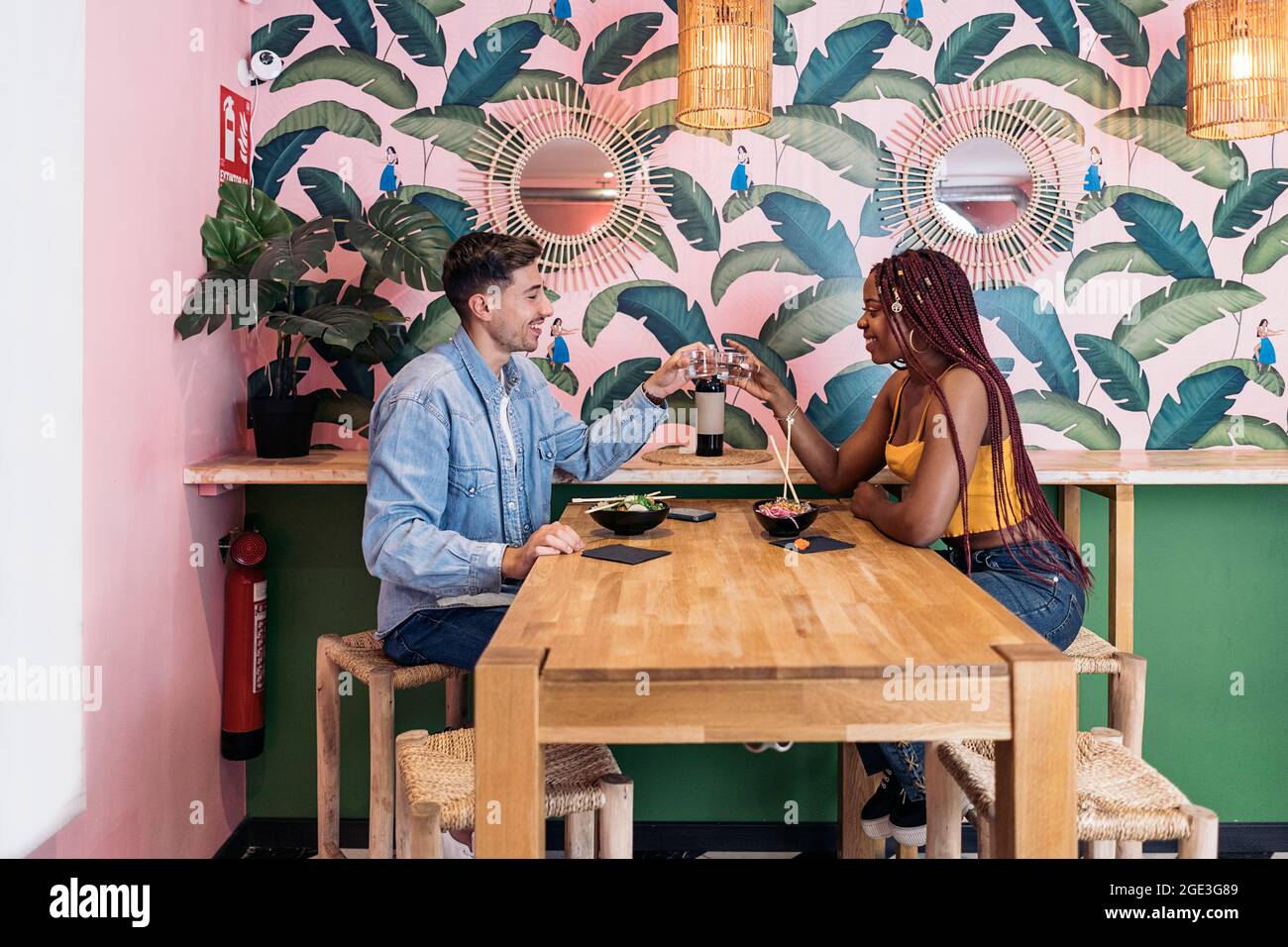 Multicultural friends sitting in a restaurant and enjoying a healthy ...