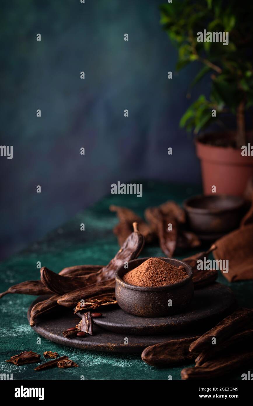 Carob pods, powder and molasses or syrup Stock Photo - Alamy