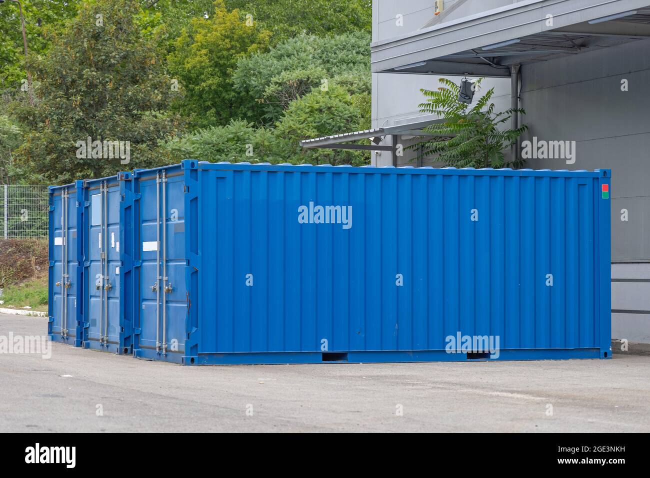 Three Blue Cargo Containers at Ground in Yard Stock Photo - Alamy