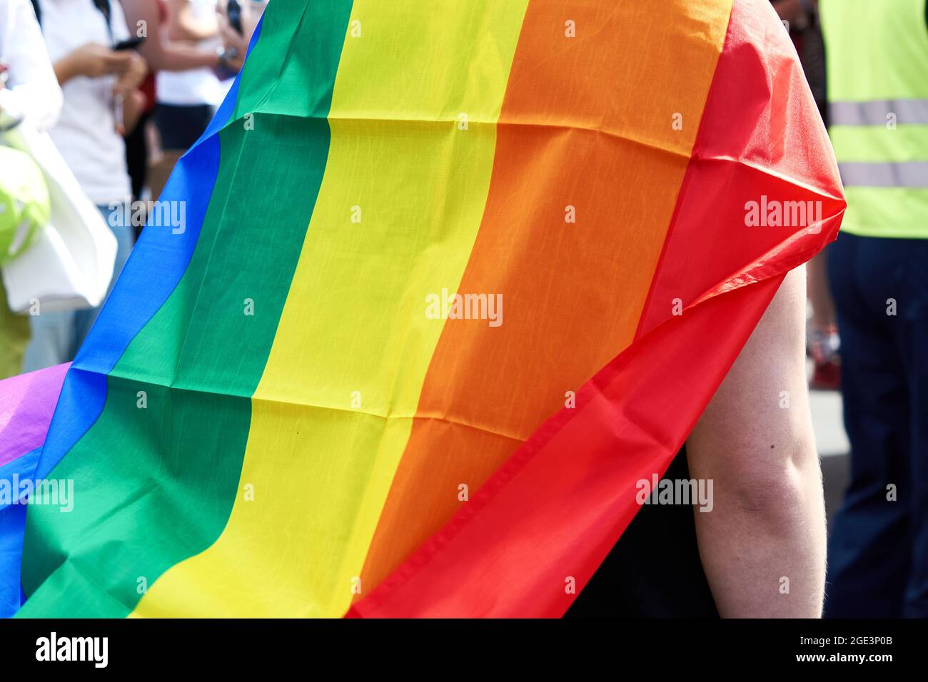 Close up of rainbow flag cape worn over shoulders by CSD participant ...