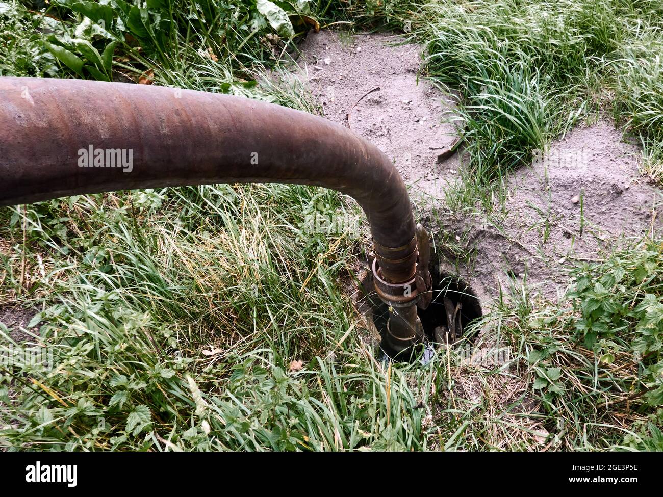 Well with inserted hose for the extraction of groundwater for the ...