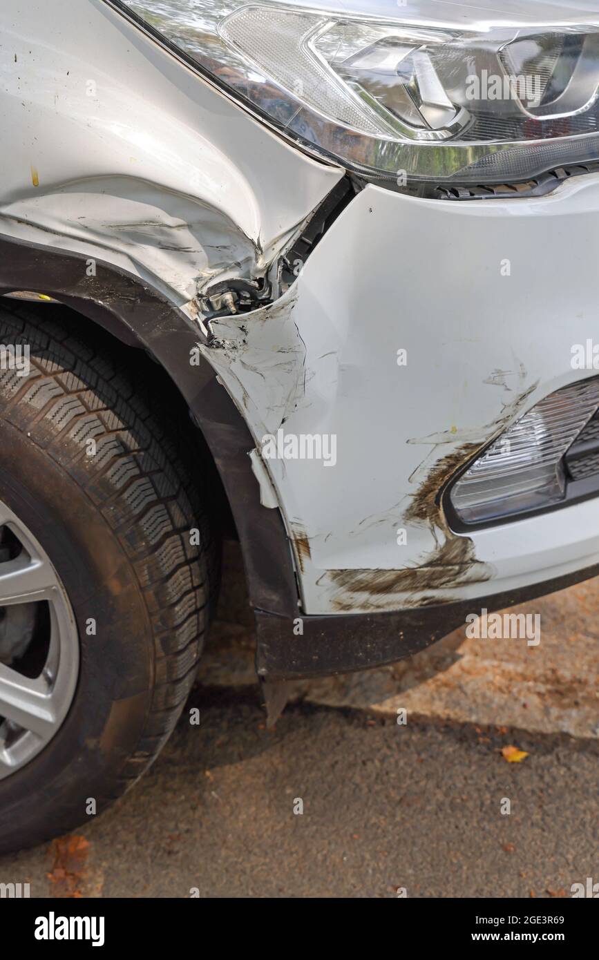 Small Accident Damage at Front of New White Vehicle Stock Photo - Alamy