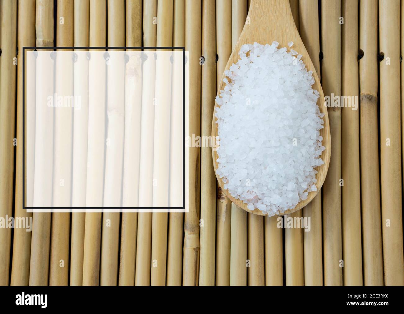 Composition of salt on spoon over wooden background Stock Photo - Alamy