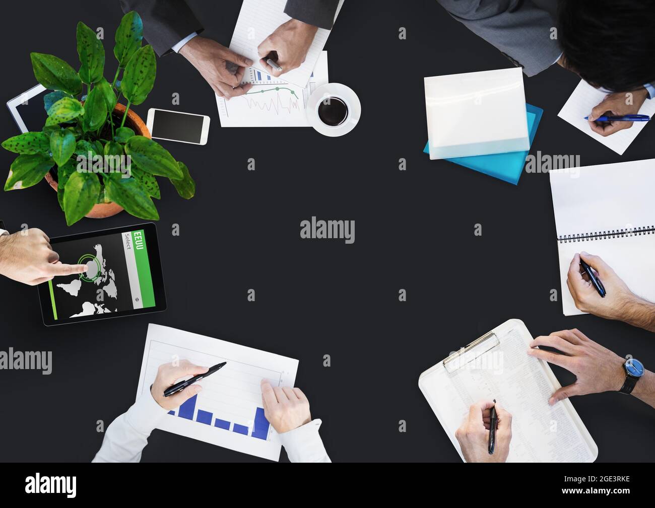 Composition of business people taking notes during meeting in office ...