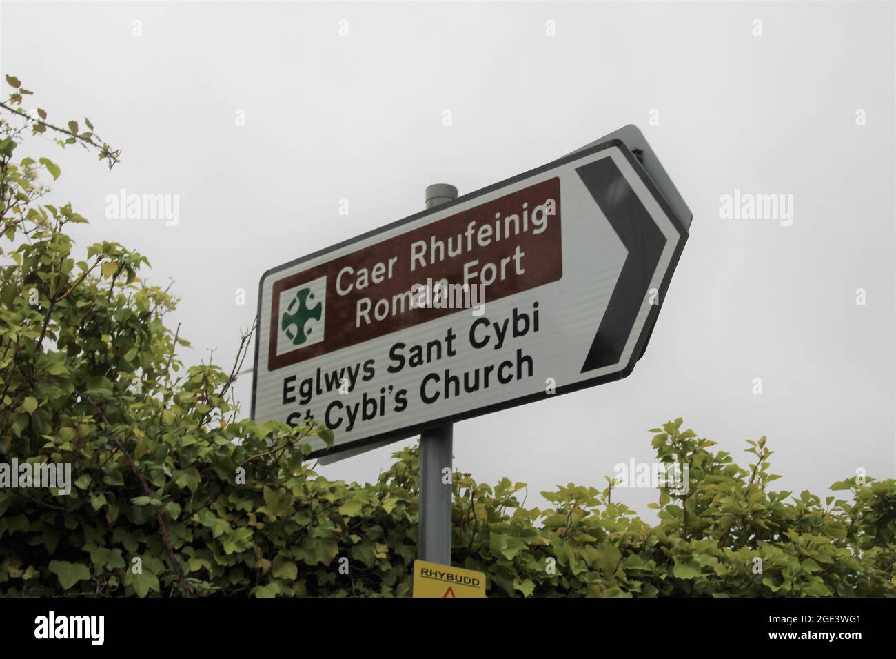 A sign pointing to the direction of a Roman fort and St. Cybi's Church ...