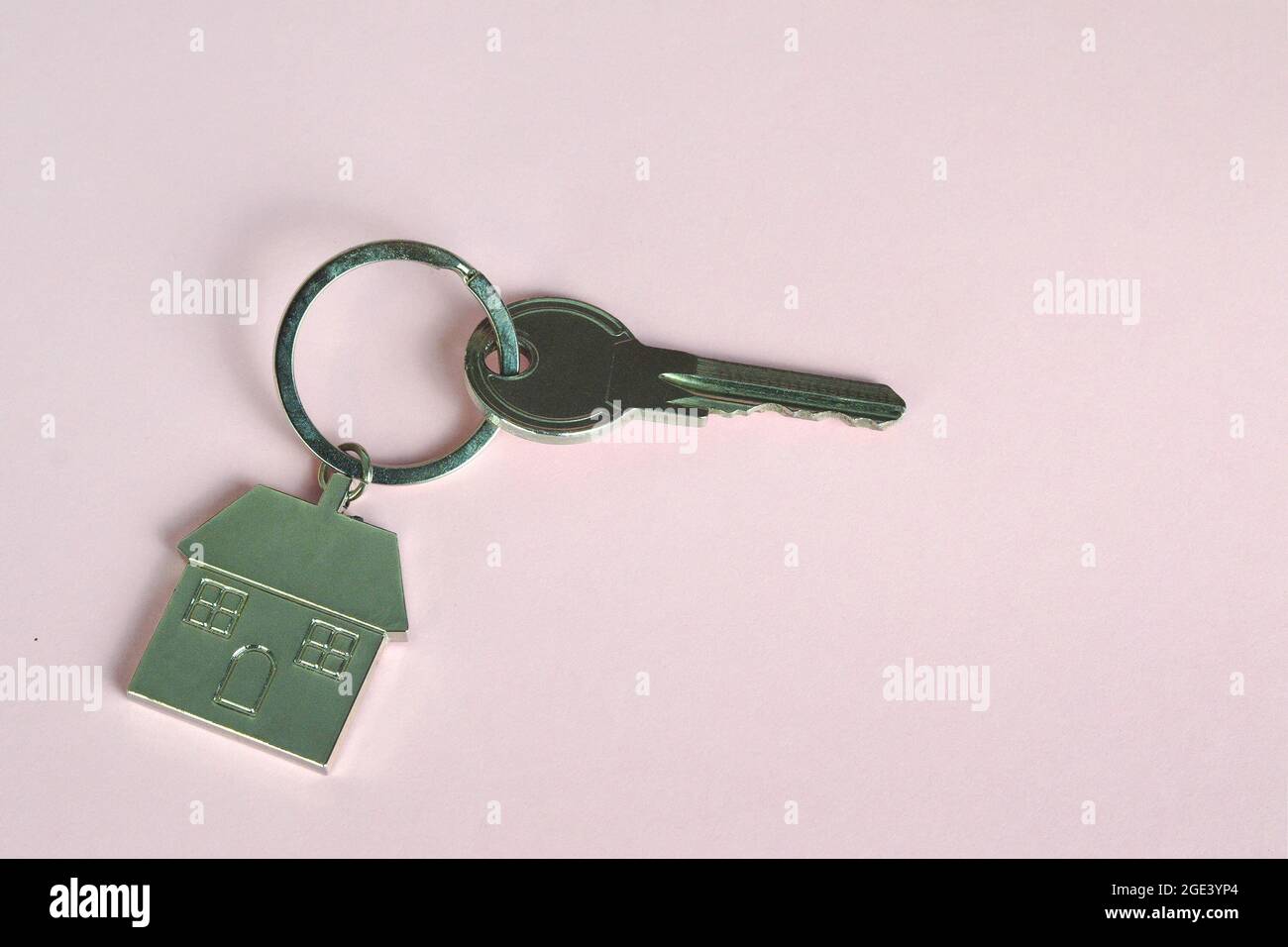 Key and house shaped pendant on pink background with copy space Stock ...