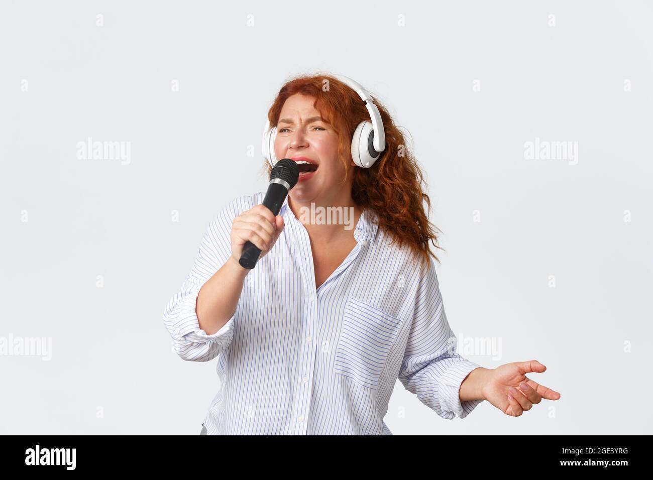 Emotions, lifestyle and leisure concept. Carefree passionate redhead middle-aged woman enjoying ...