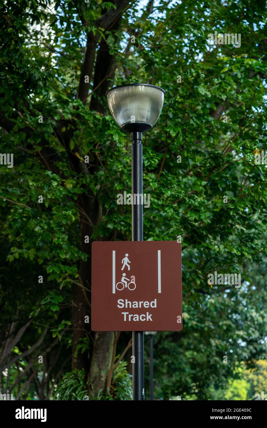 Sign of shares track for bicycles and pedestrians, Singapore park ...
