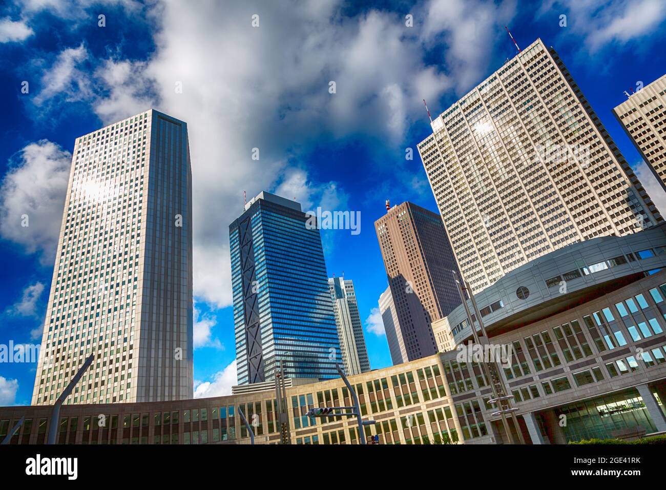 Tokyo urban cityscape, with high-rise office buildings. Blue sky and ...