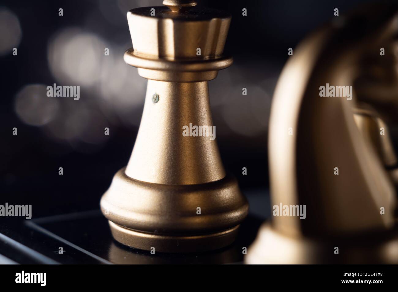 Selective-focus shot of a white rook piece on a chessboard with bokeh ...