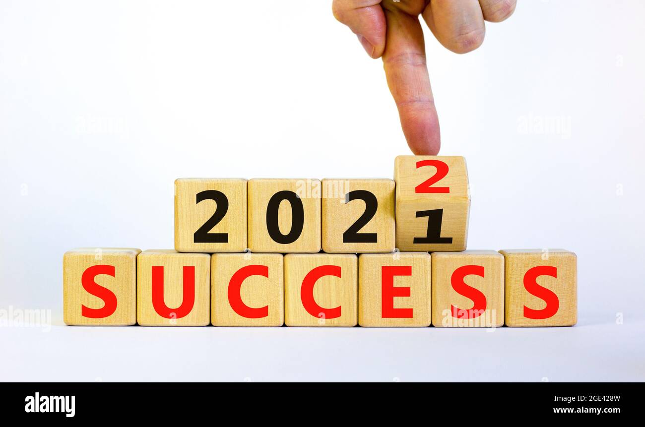 Planning 2022 success new year symbol. Businessman turns a wooden cube ...