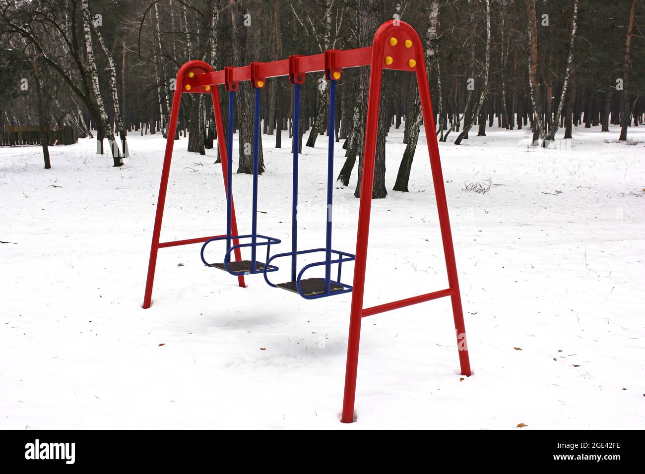 Children's swing. Winter. Playground. Children's playground is empty in ...