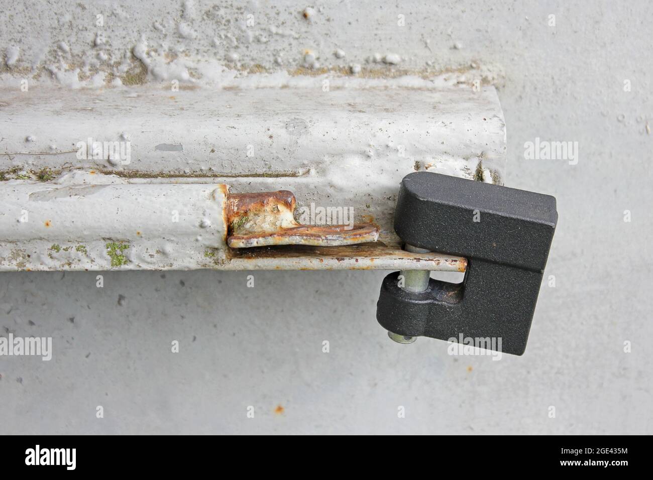 Large lock on the gate. Primitive property protection Stock Photo - Alamy