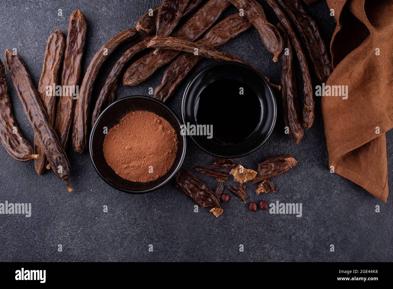 Carob pods, powder and molasses or syrup Stock Photo - Alamy