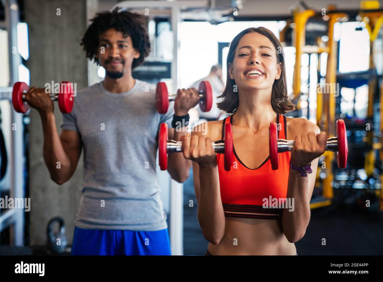 Picture of cheerful fitness team exercise together in gym Stock Photo ...