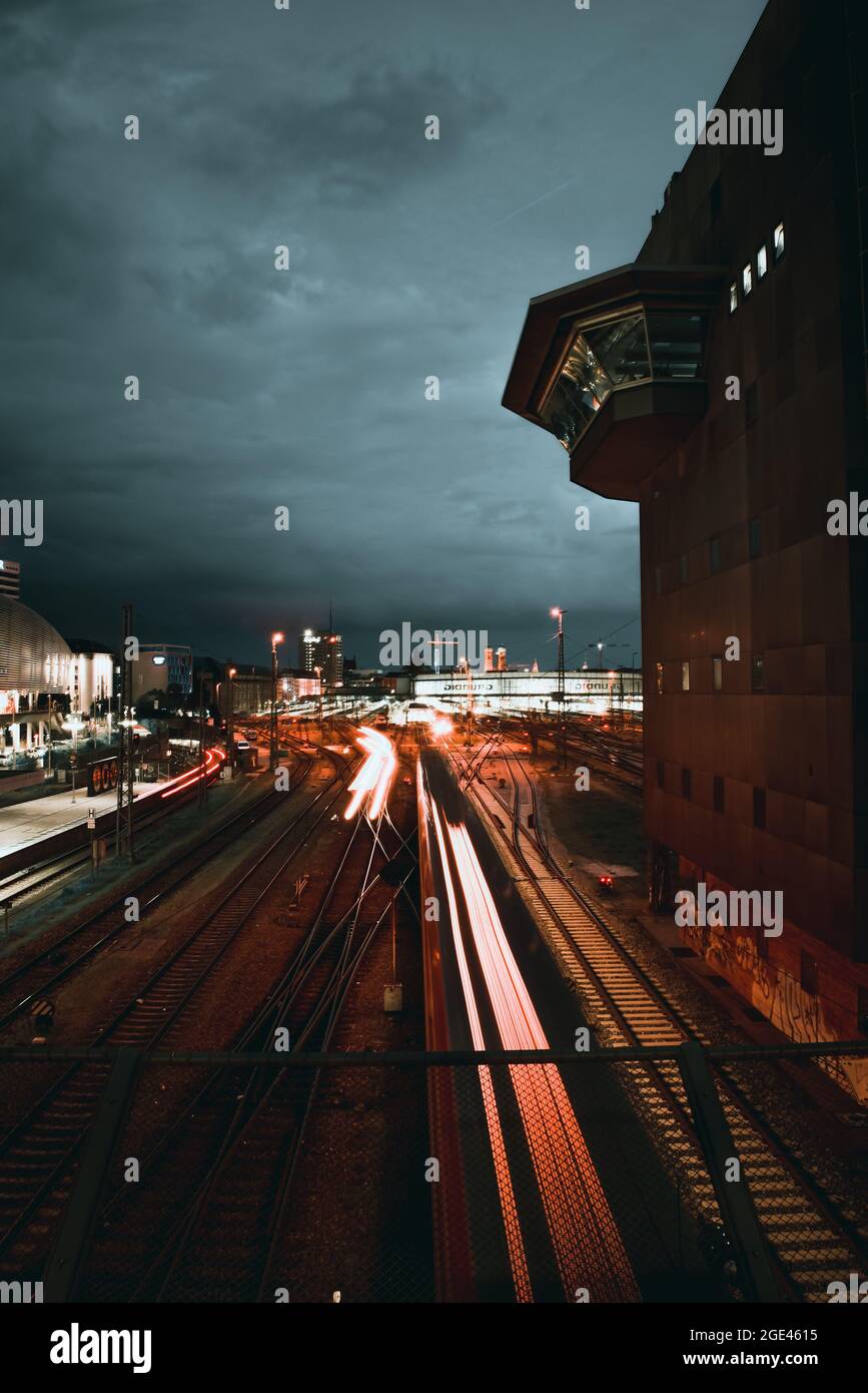 Railway track in the city at night Stock Photo - Alamy