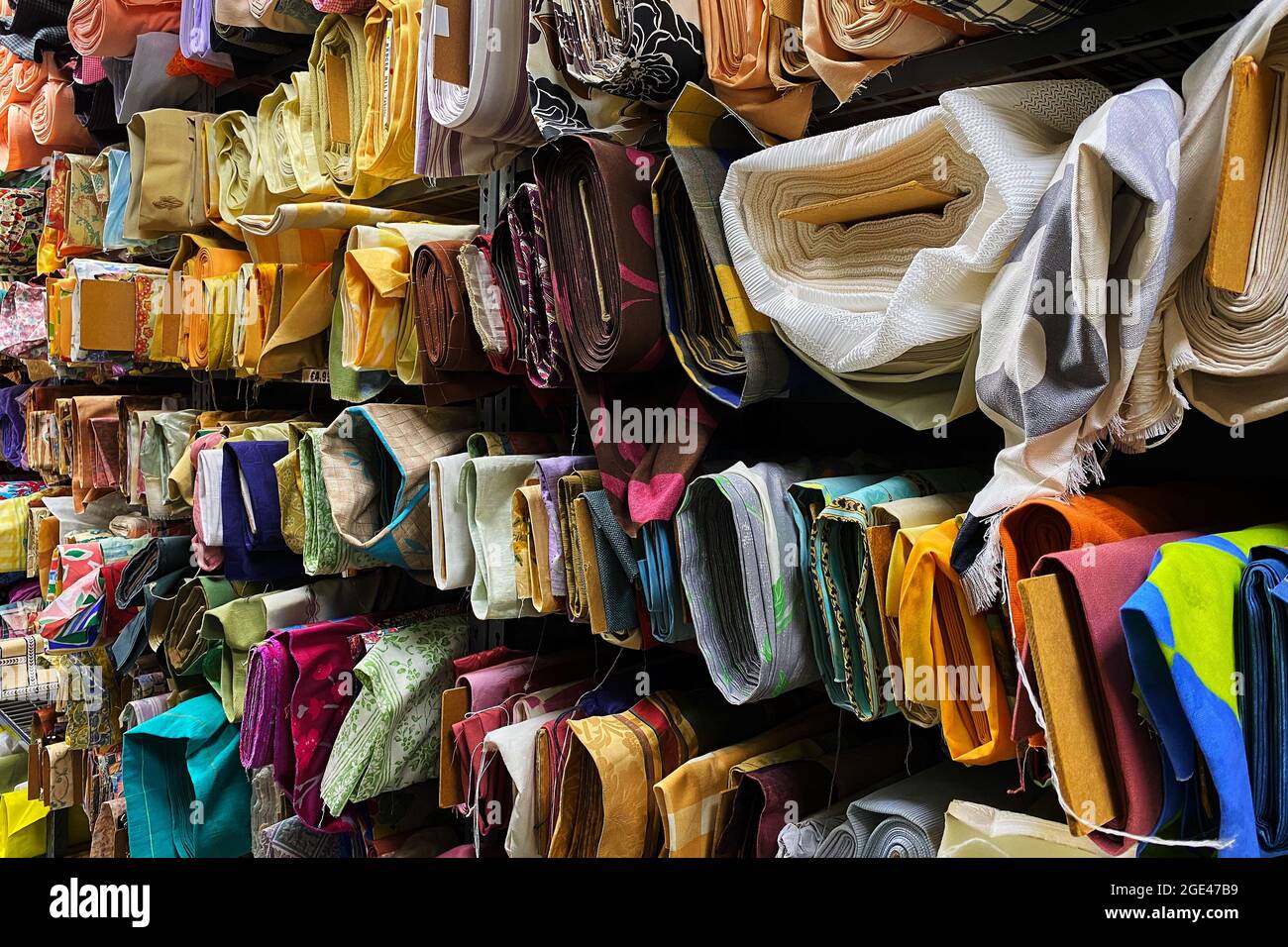 Closeup view of different color rolls of materials being sold in a ...