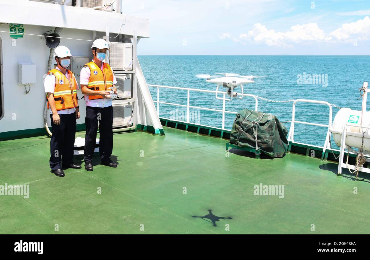 Haikou. 16th Aug, 2021. Members of Hainan maritime authority use a ...