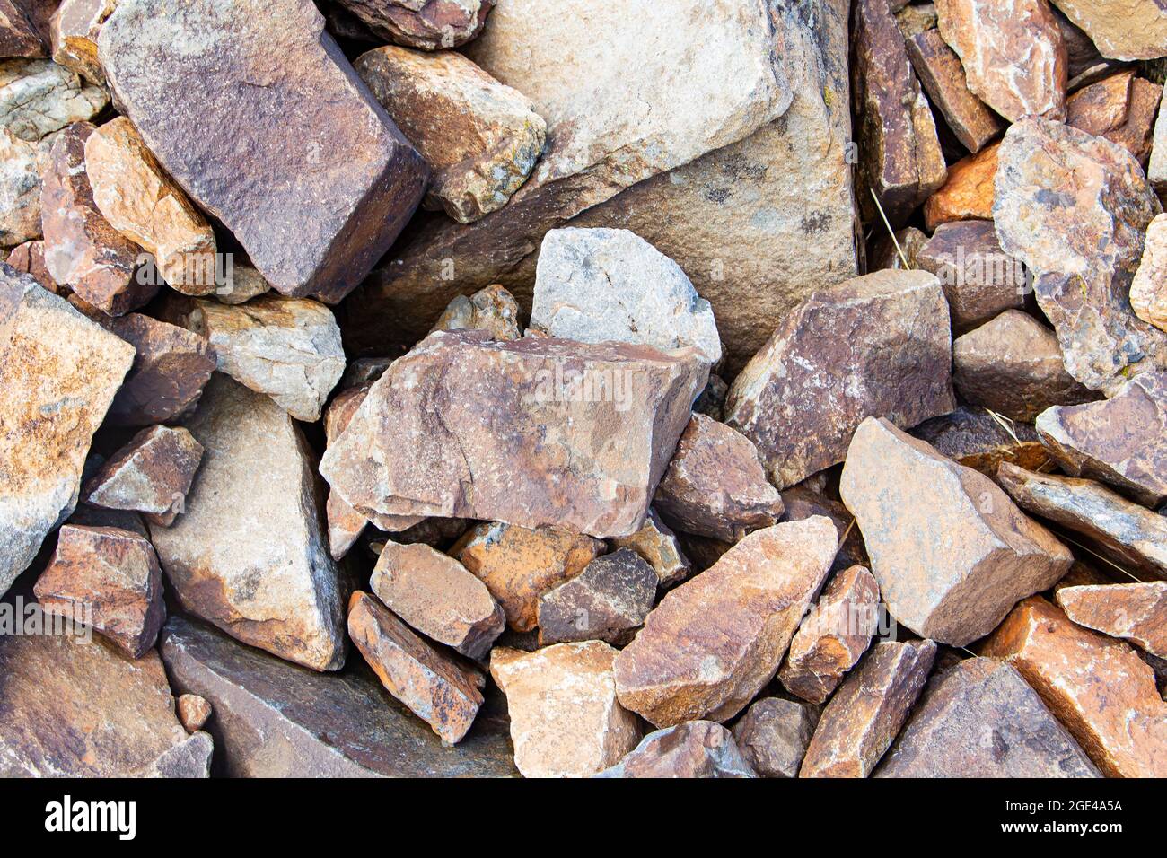 Rockfall on the road in the mountains. Stones of different sizes ...