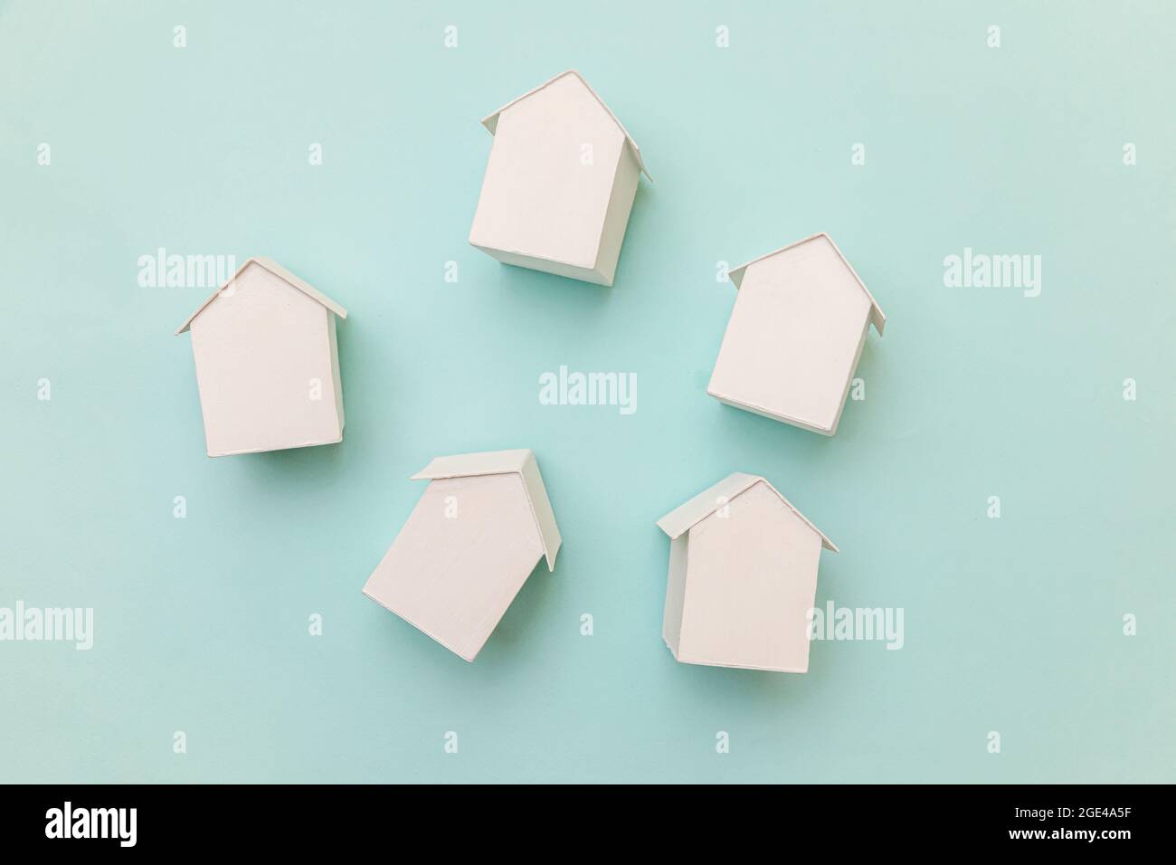 Simply flat lay design with miniature white toy model houses isolated ...