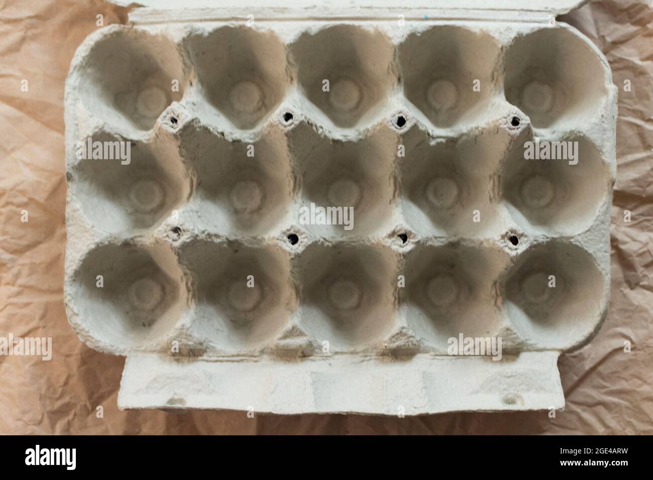 Opened empty egg cardboard box isolated on crumpled kraft paper ...