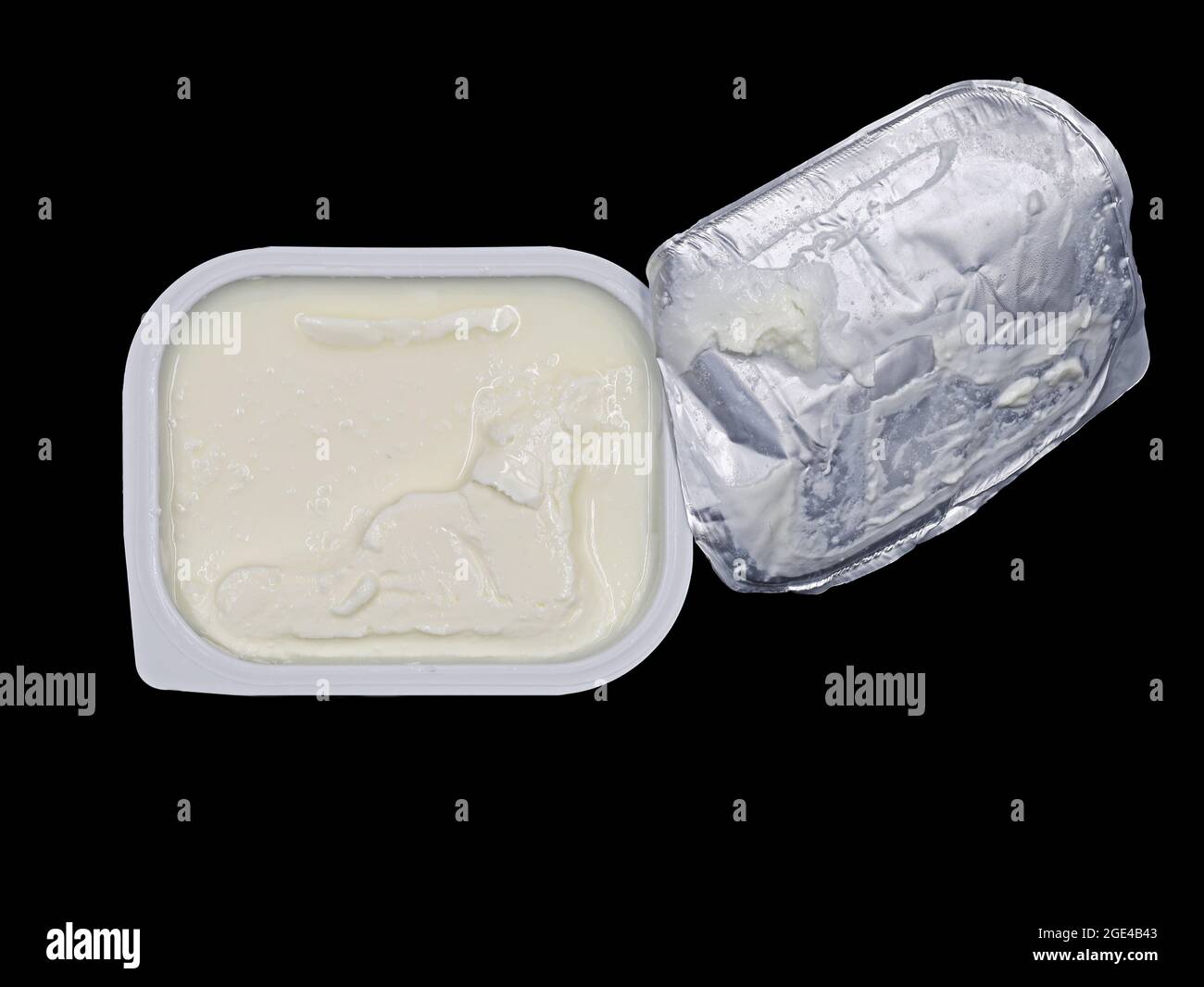 top view of quark or cream cheese in white plastic container isolated ...