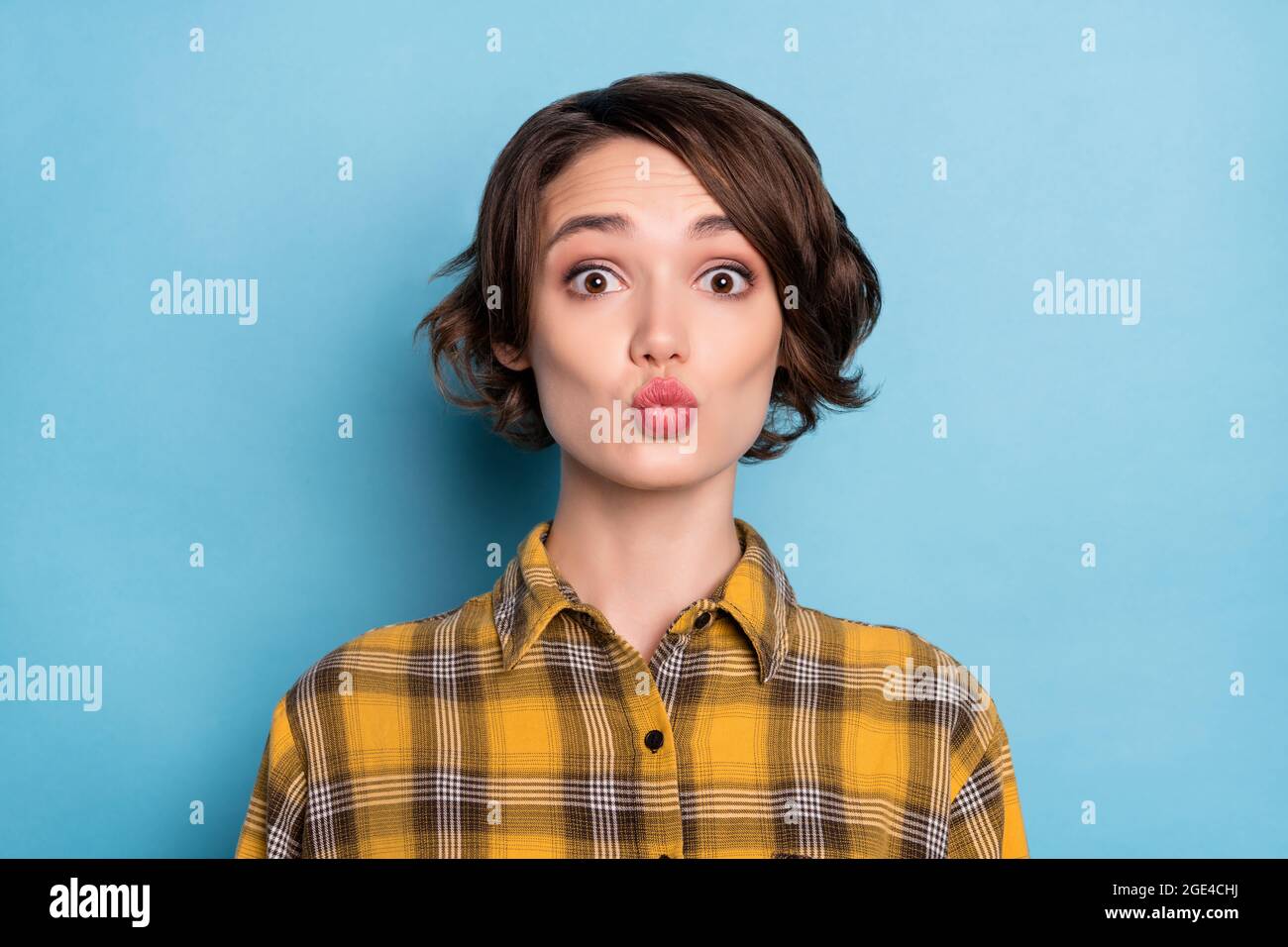 Photo of romantic dream girl send air kiss look camera wear checkered ...