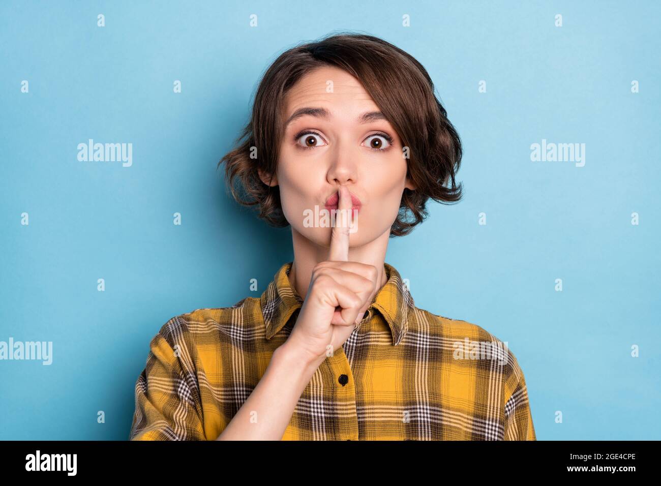 Photo of speechless girl finger cover lips ask keep silence wear ...