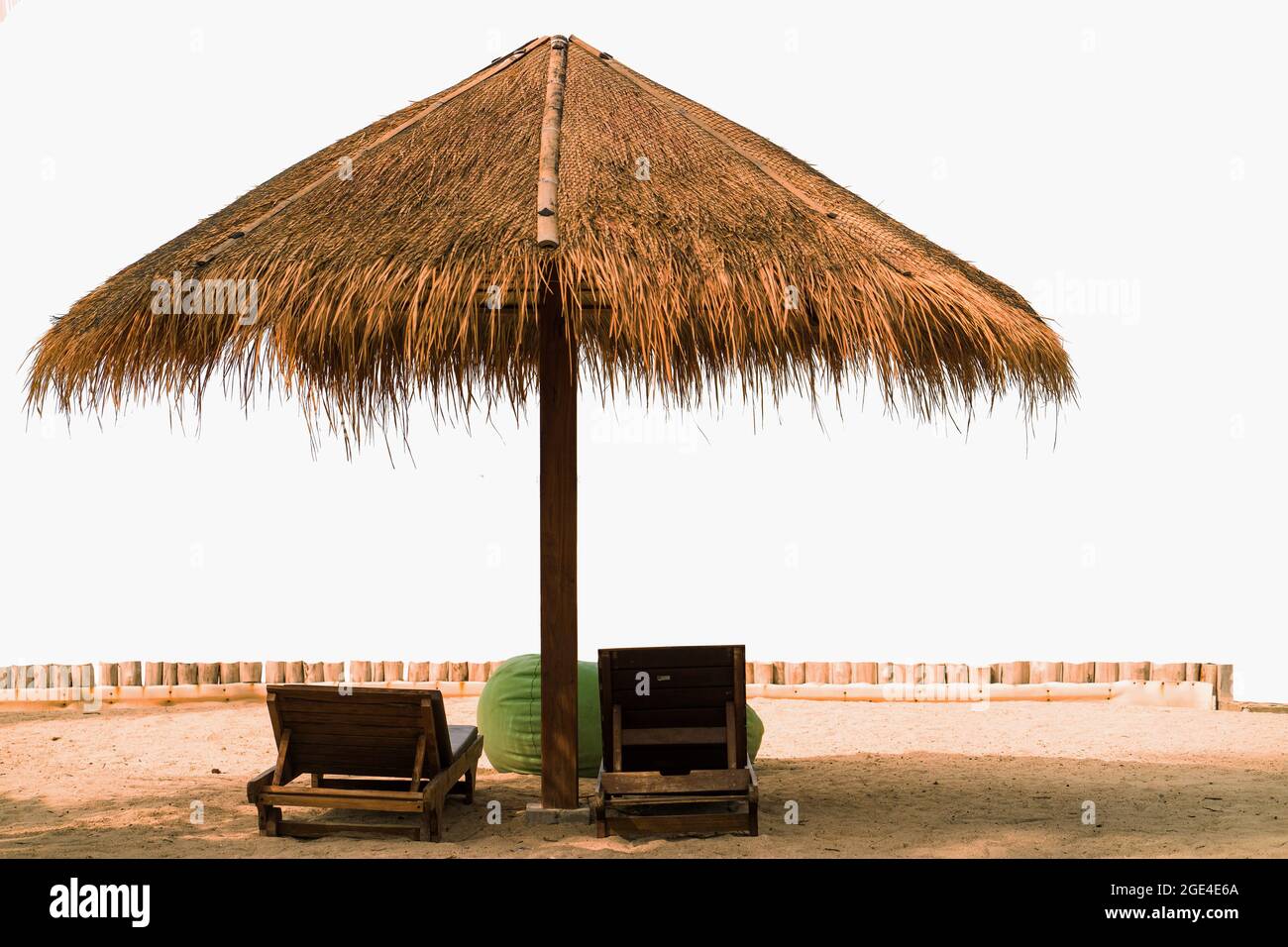 Straw parasol and sunbeds on the beach Stock Photo - Alamy