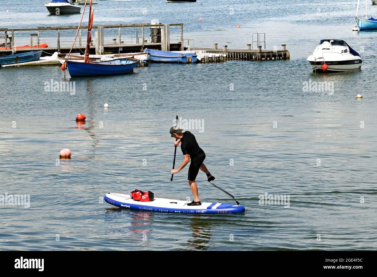 Poole, Dorset, England - June 2021: Paddle boarder balancing on one leg ...