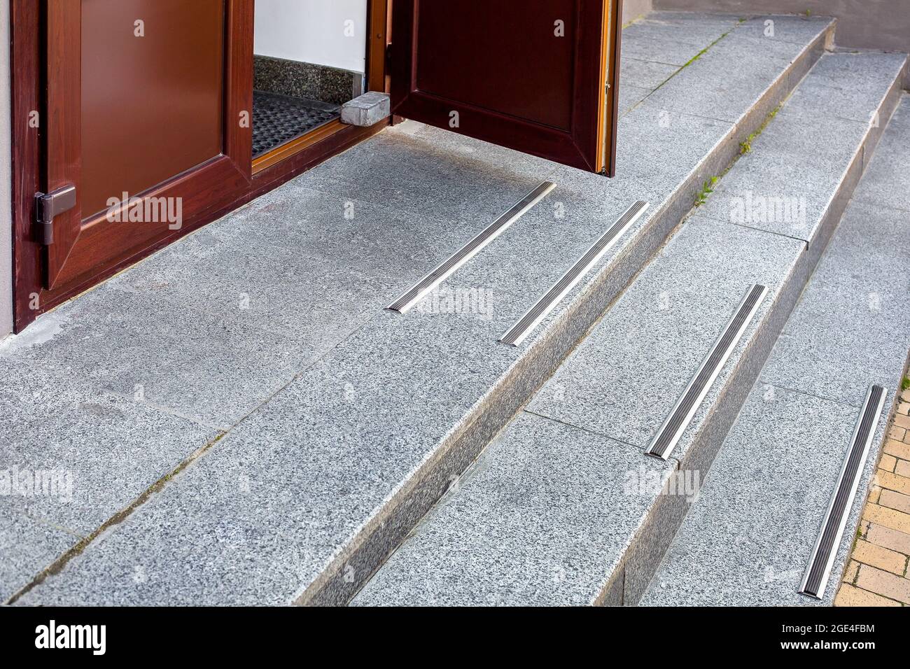 granite threshold at the open brown entrance door with rubber non-slip ...