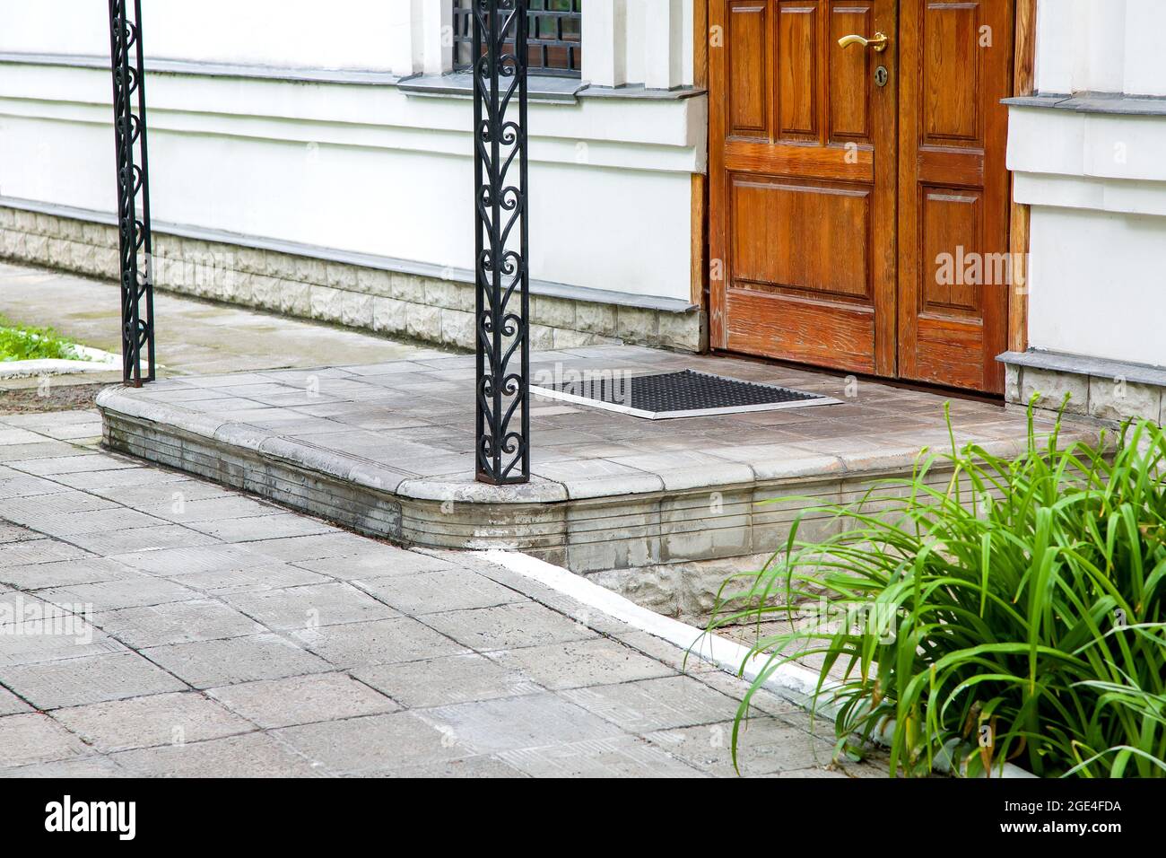 rubber foot mat at the front door of the threshold on the porch of a ...