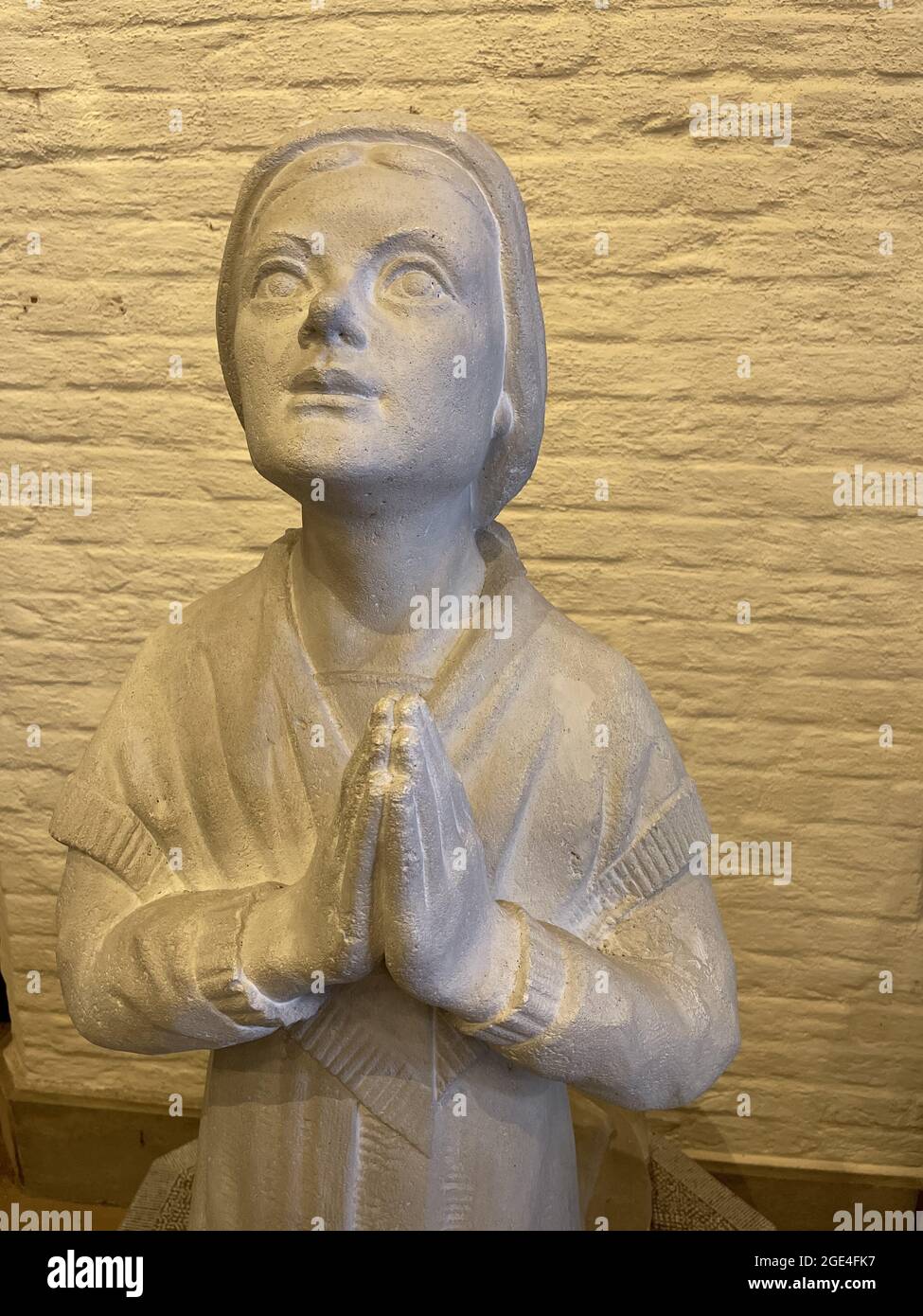 Vertical shot of a stone statue of a young praying female Stock Photo ...
