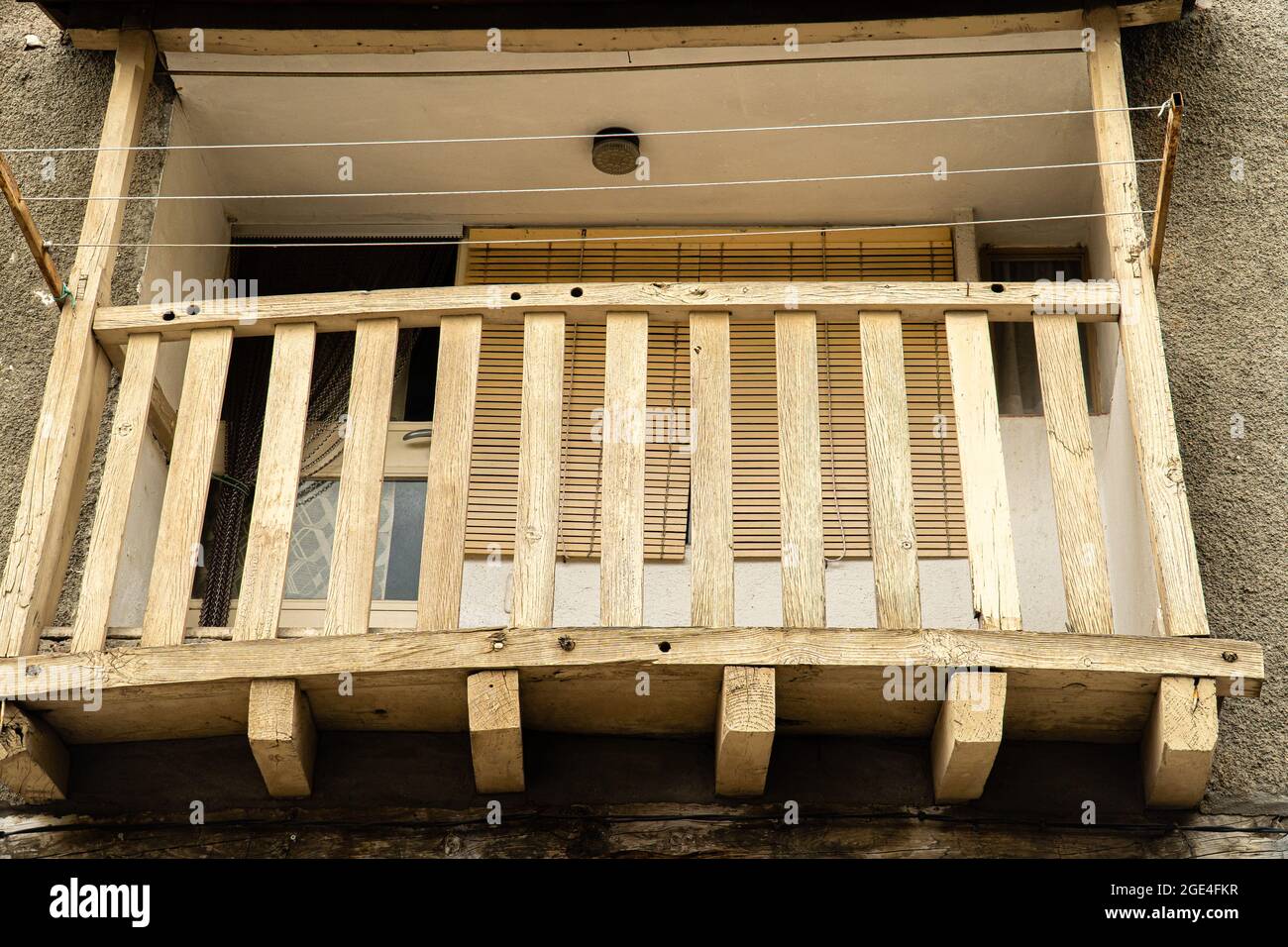 Low angle shot of an old building with a hanging wooden balcony Stock ...