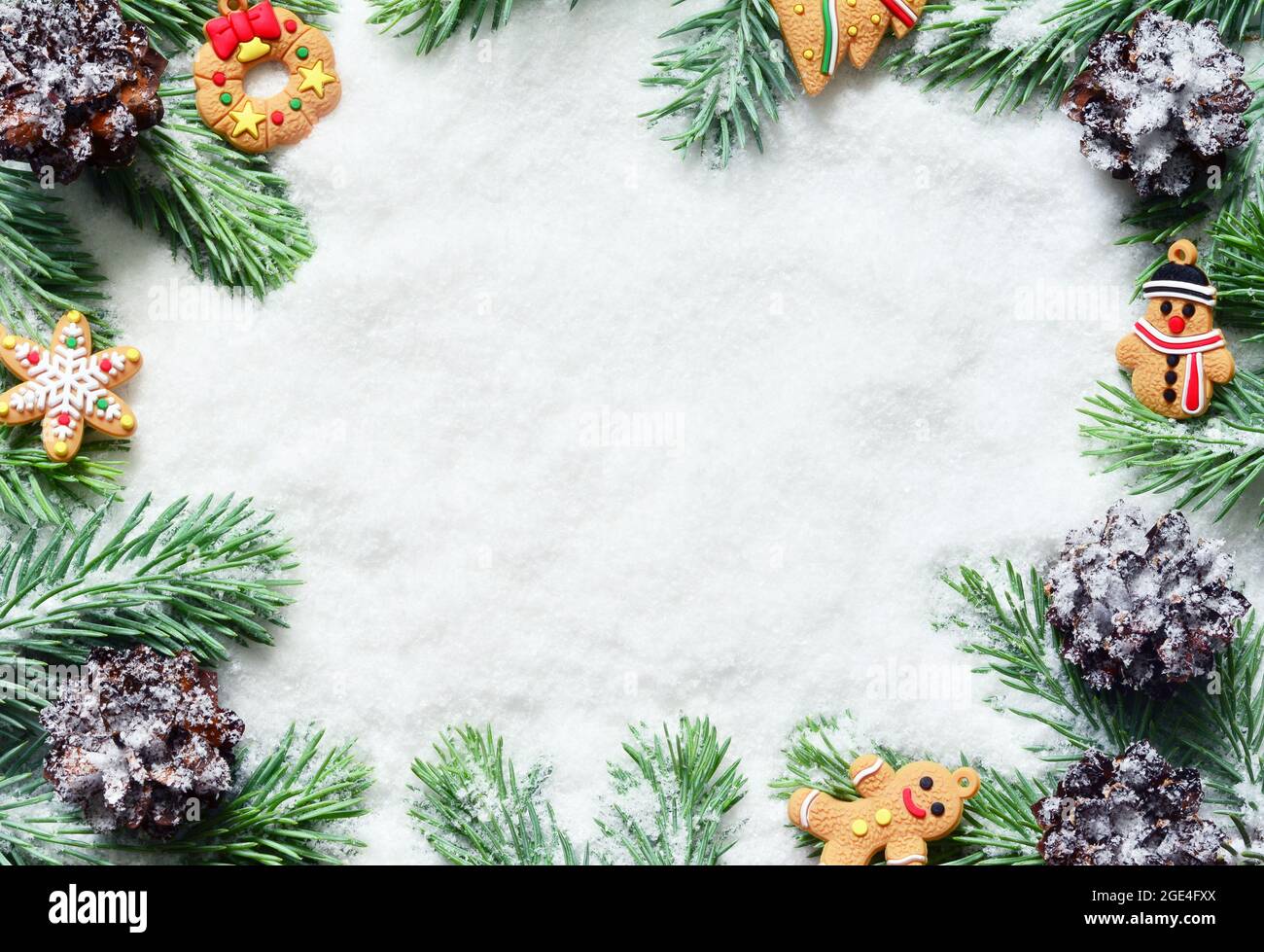 Christmas snowy background with cookie figures and cones. Holiday ...