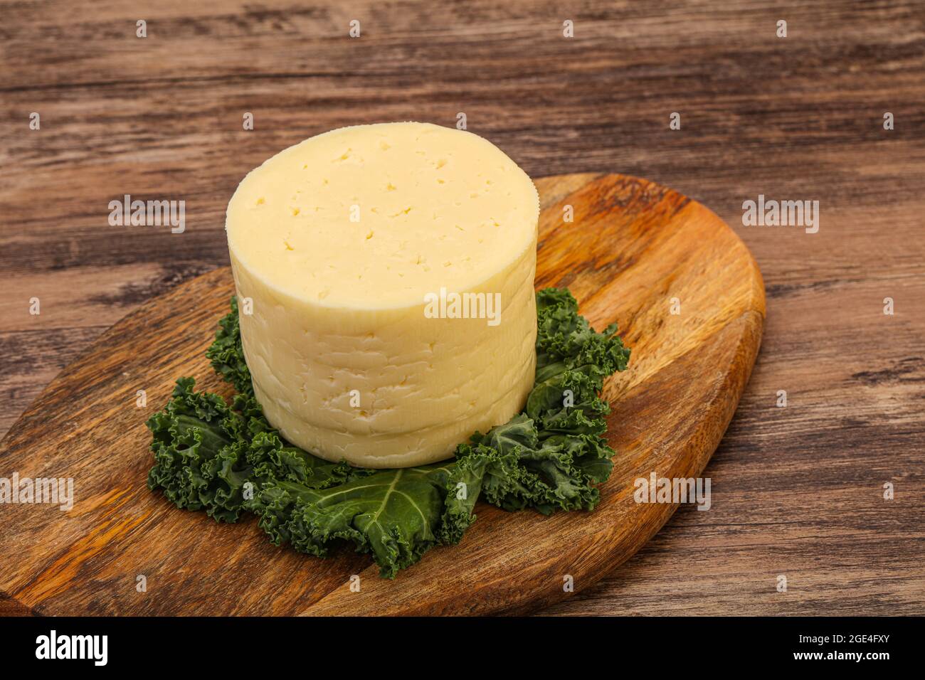 Yellow round dairy soft cheese piece Stock Photo - Alamy