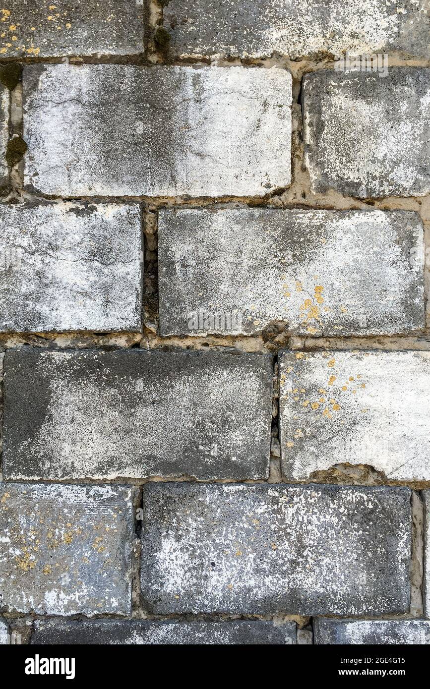 Old vintage retro style grey brick wall at street, decrepit with time ...