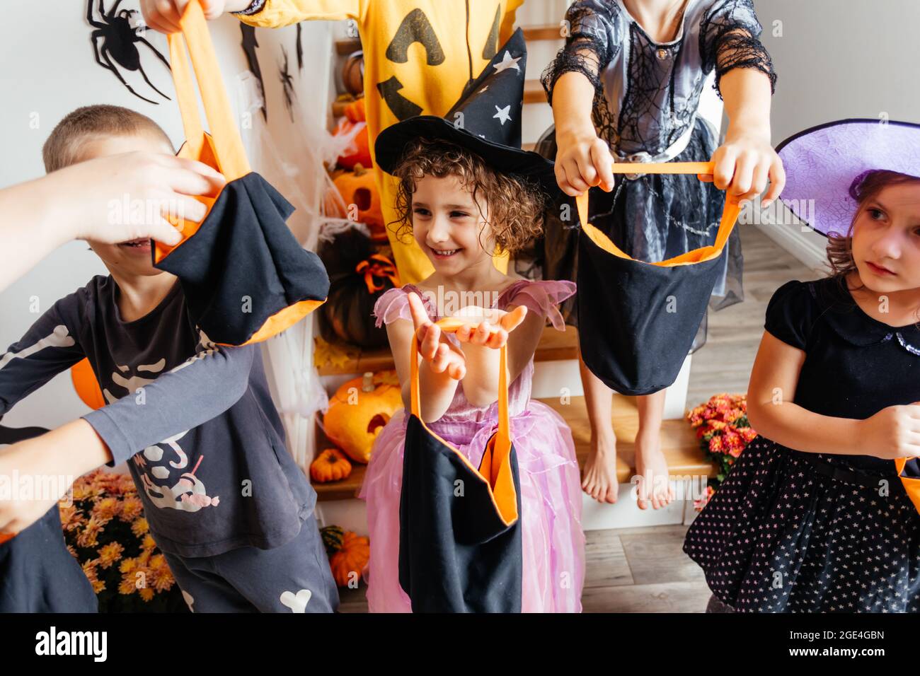 Group of kids waiting for Halloween candies Stock Photo - Alamy