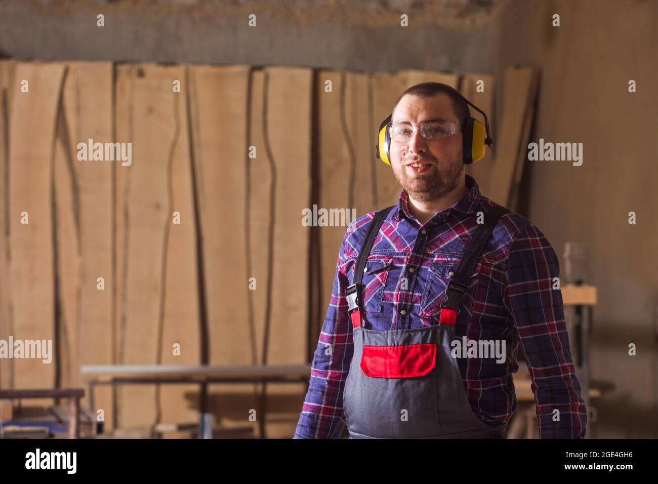 the carpenter wearing safety clothes in the factory Stock Photo - Alamy