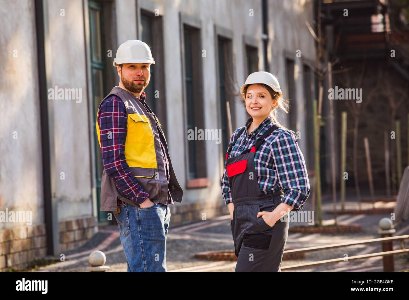 Two young engineers outdoors at the factory Stock Photo - Alamy