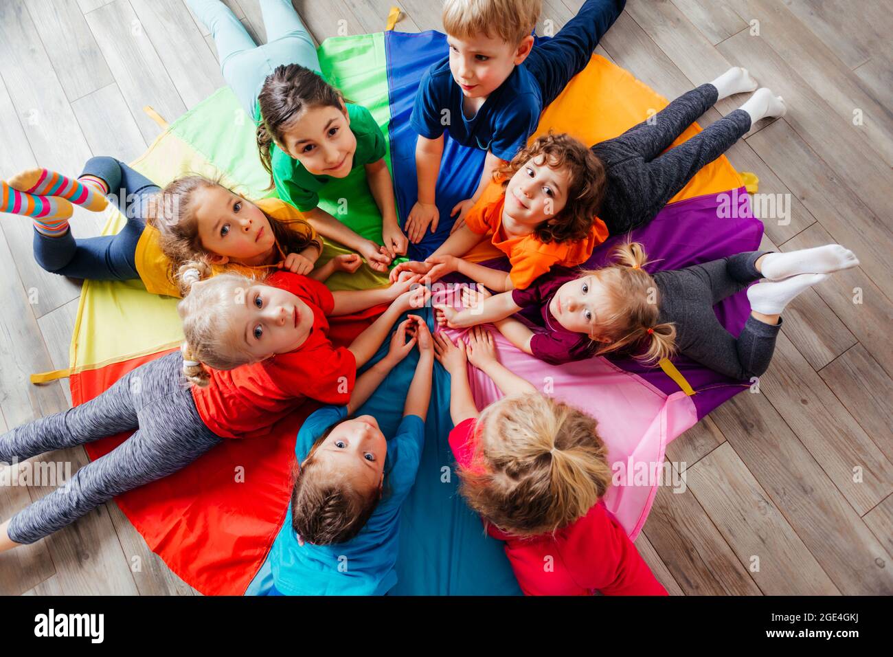 Happy kids laying on a floor in circle Stock Photo - Alamy