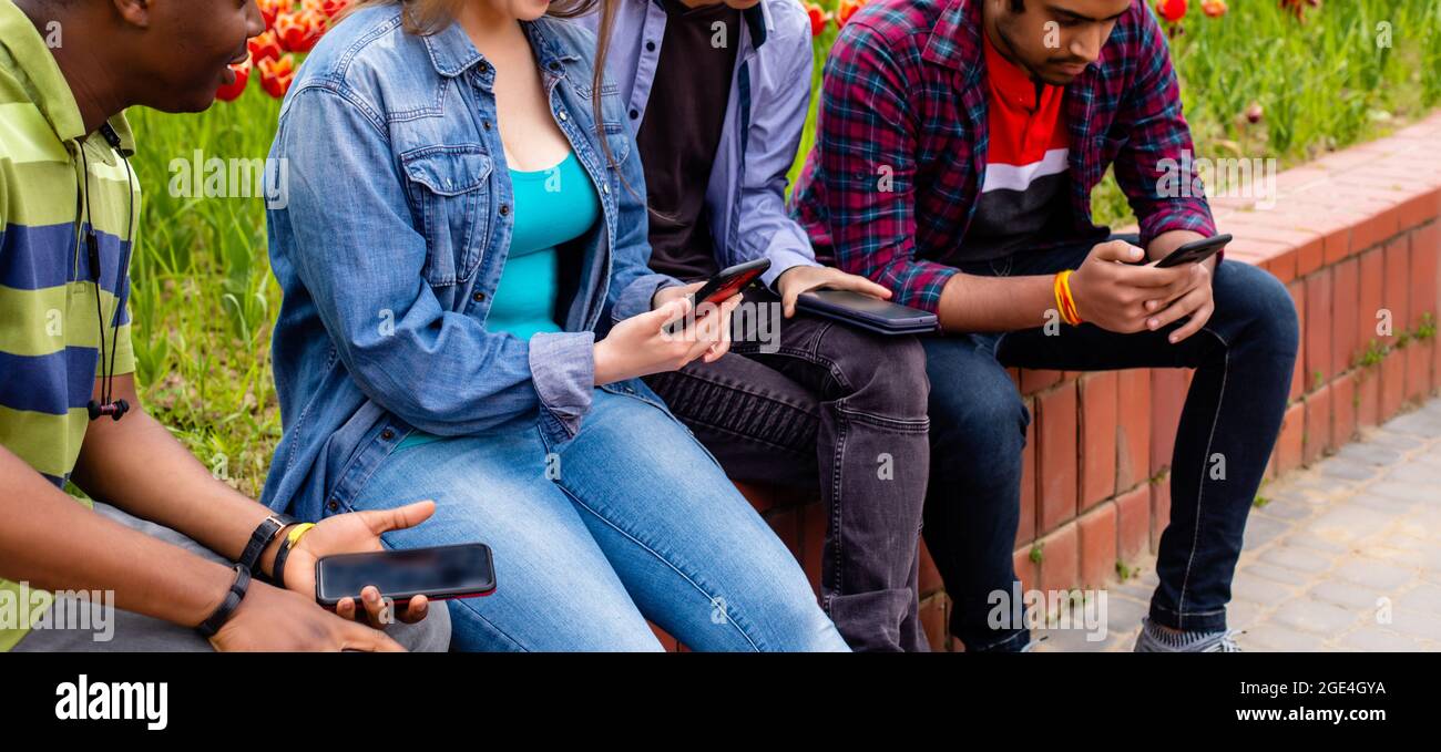 Young girl feeling happy among three multiracial male friends Stock ...