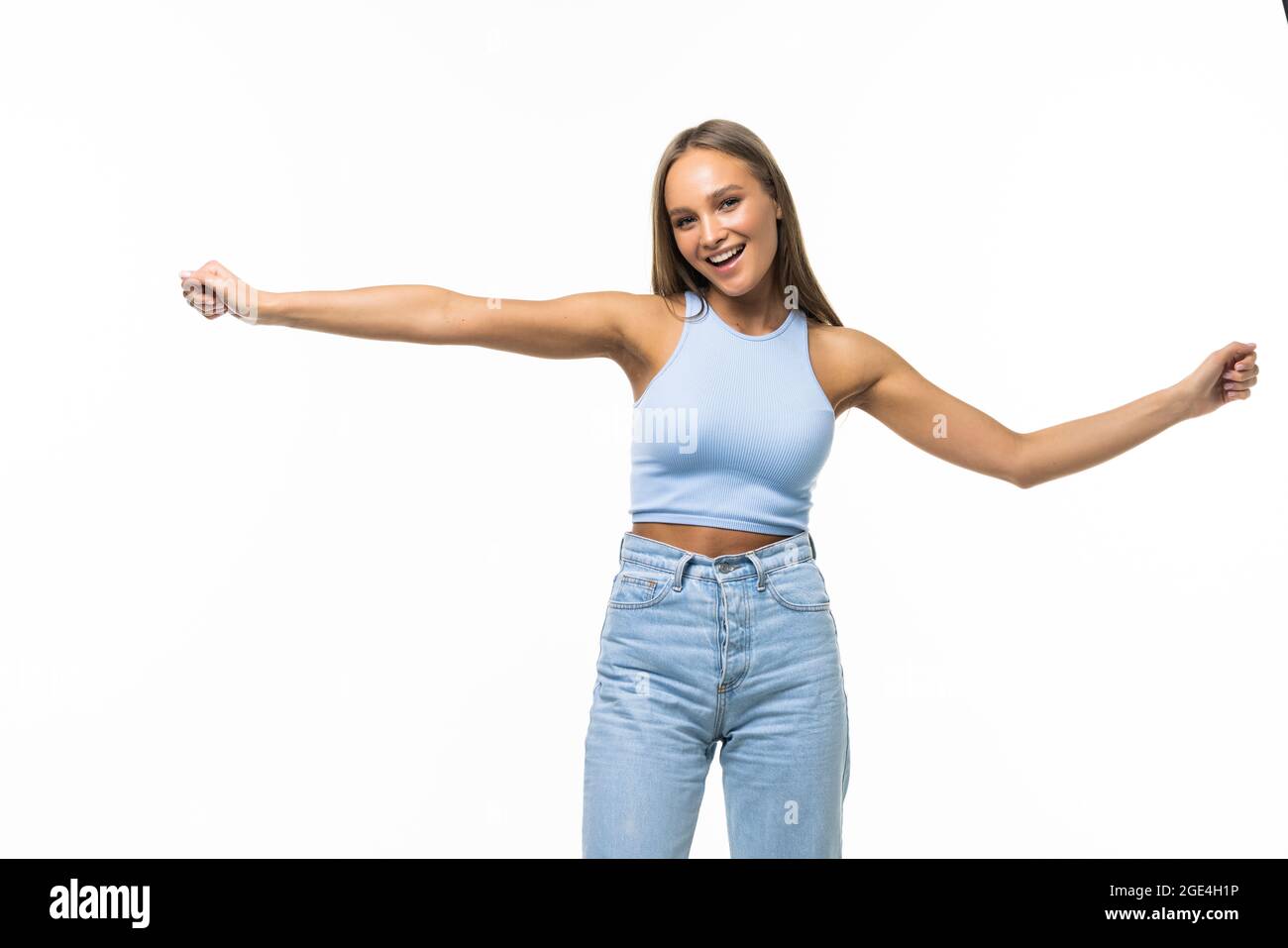 Young happy woman dancing against white background Stock Photo - Alamy