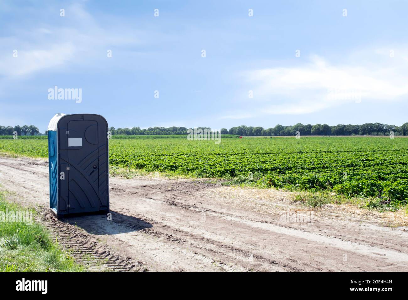 Public plastic portable toilet on agriculture field of farmer landscape ...