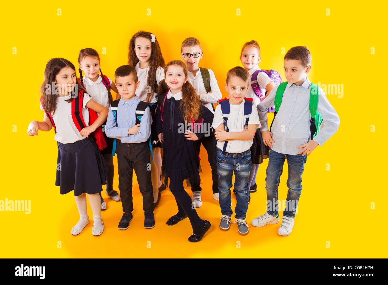 The friendly classmates are hugging on a yellow background Stock Photo ...