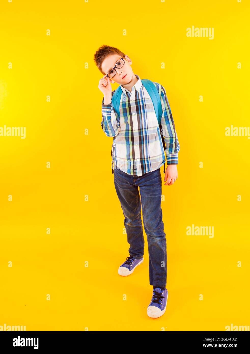 The smart schoolboy shows thumbs up in studio Stock Photo - Alamy