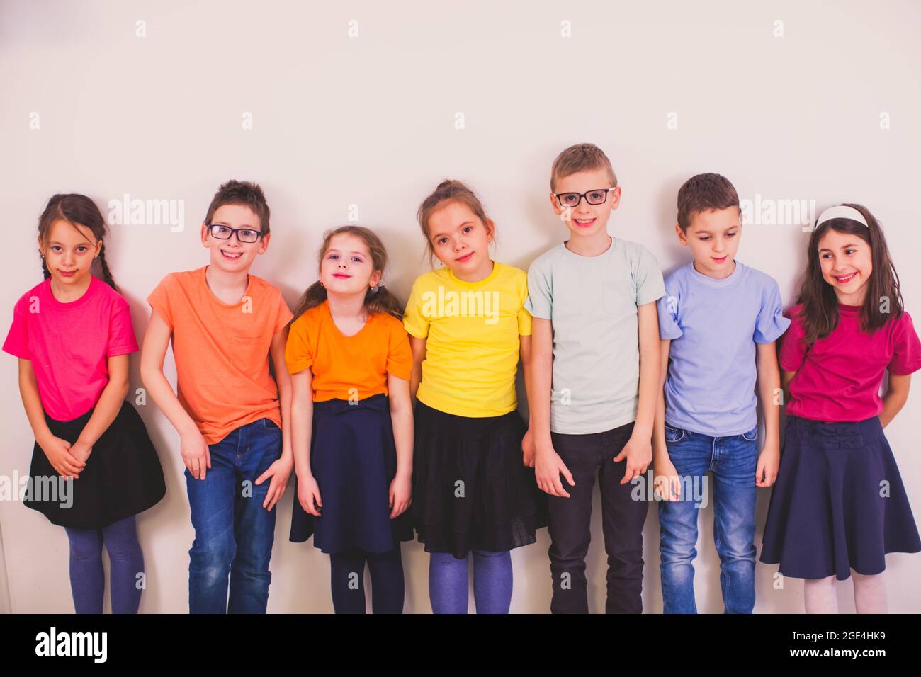 Children in colorful school uniform on white background Stock Photo - Alamy