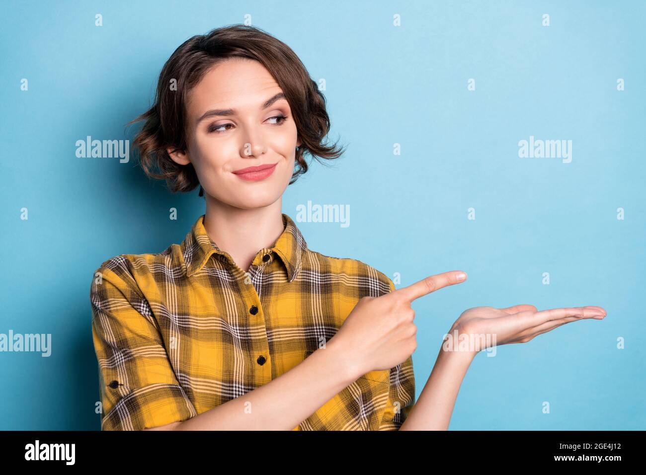 Photo of charming flirty promoter lady hand hold empty space direct ...
