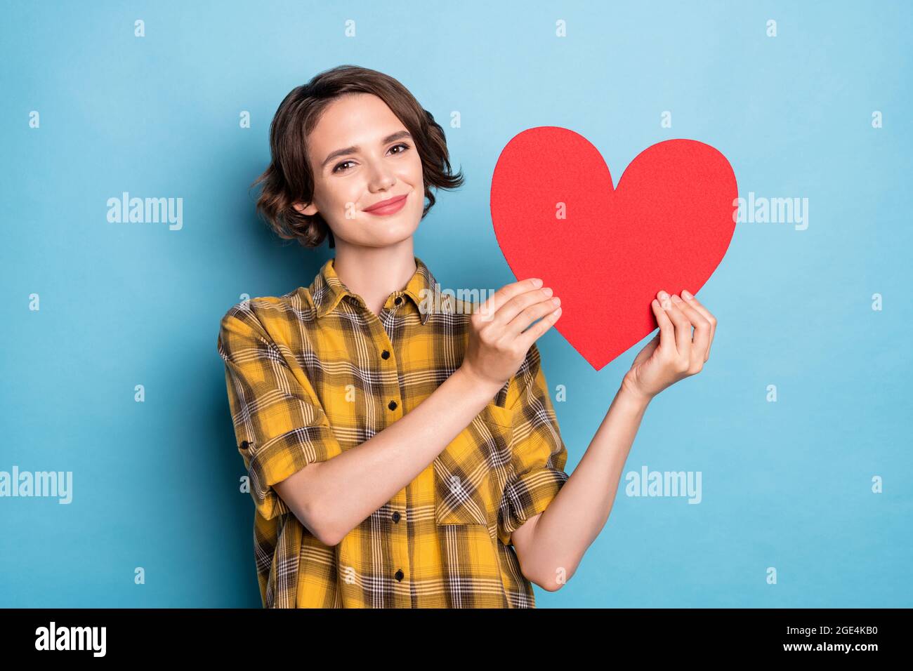 Photo of romantic affectionate lady hold red paper heart card wear ...